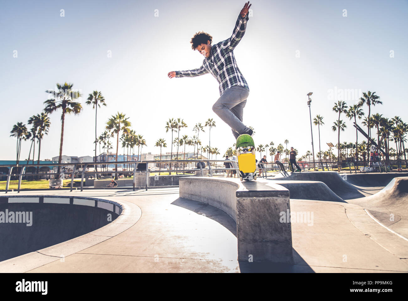 Cool skateboarder outdoors - Afroamerican guy jumping with his skate ...