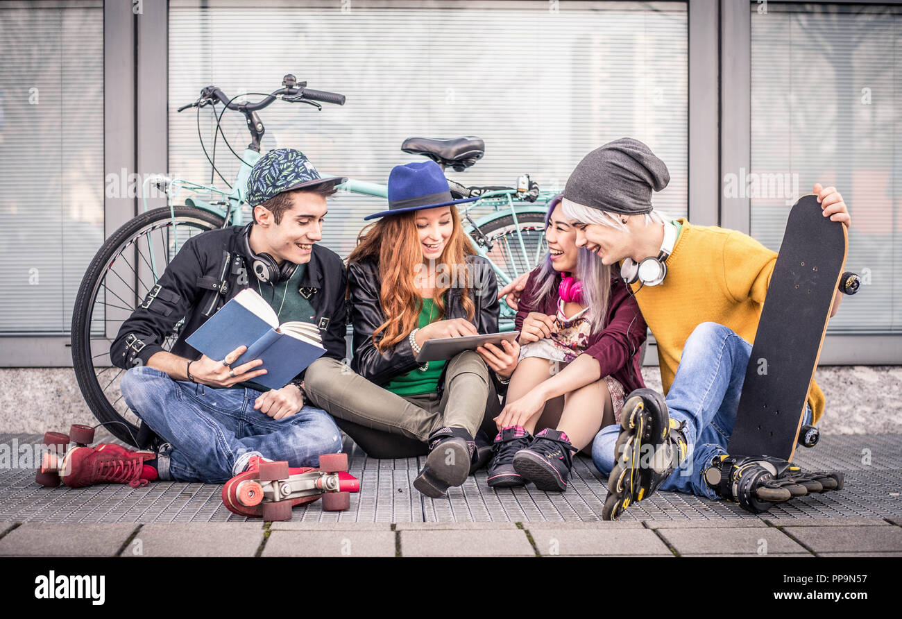 Multi-ethnic group of students stdying together outdoors in a college ...