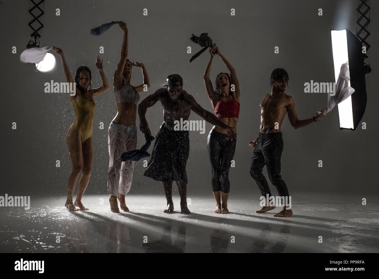 Group of dancers dancing under the rain Stock Photo - Alamy