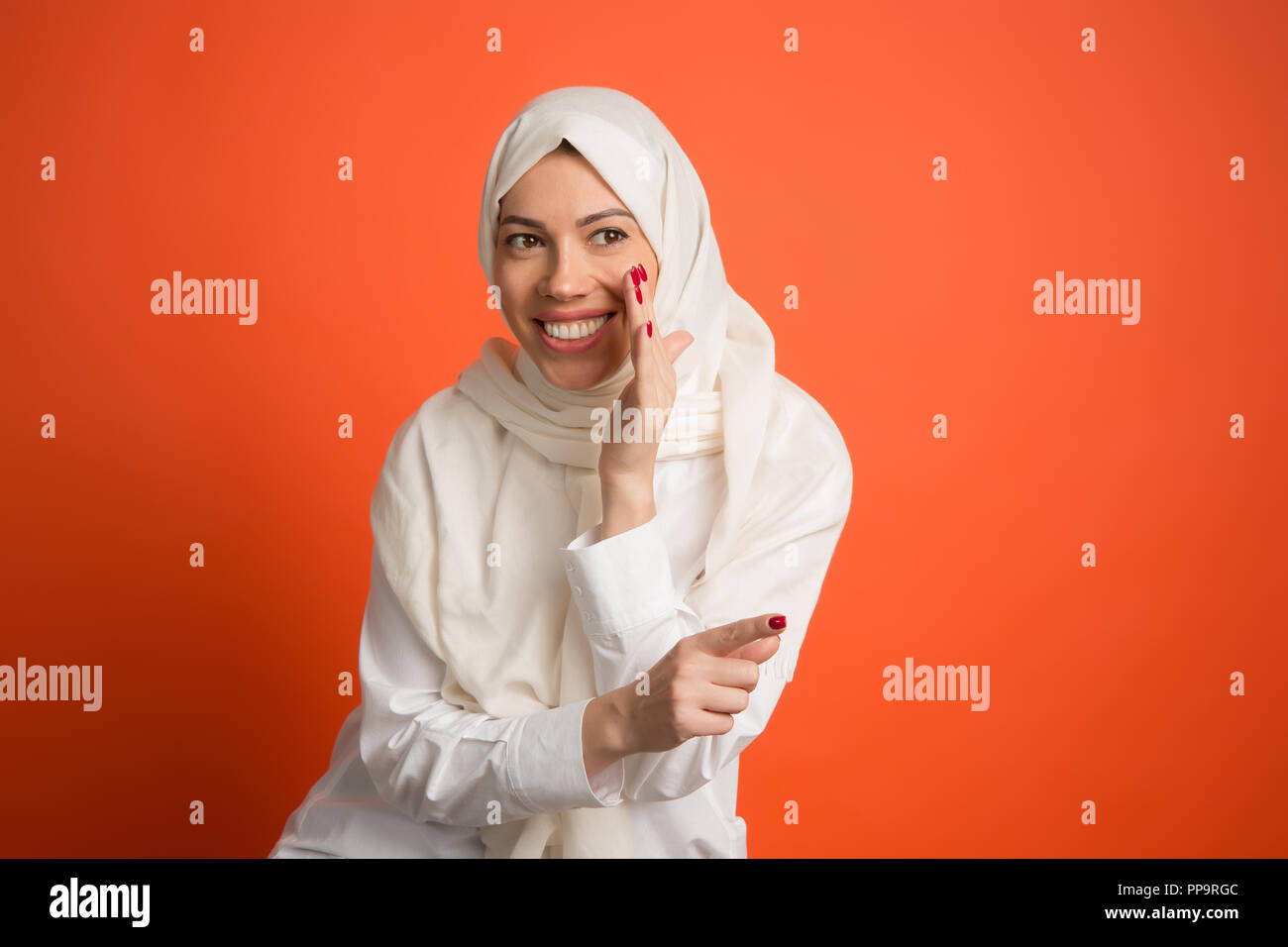 Secret, gossip concept. Happy arab woman in hijab. Portrait of smiling ...