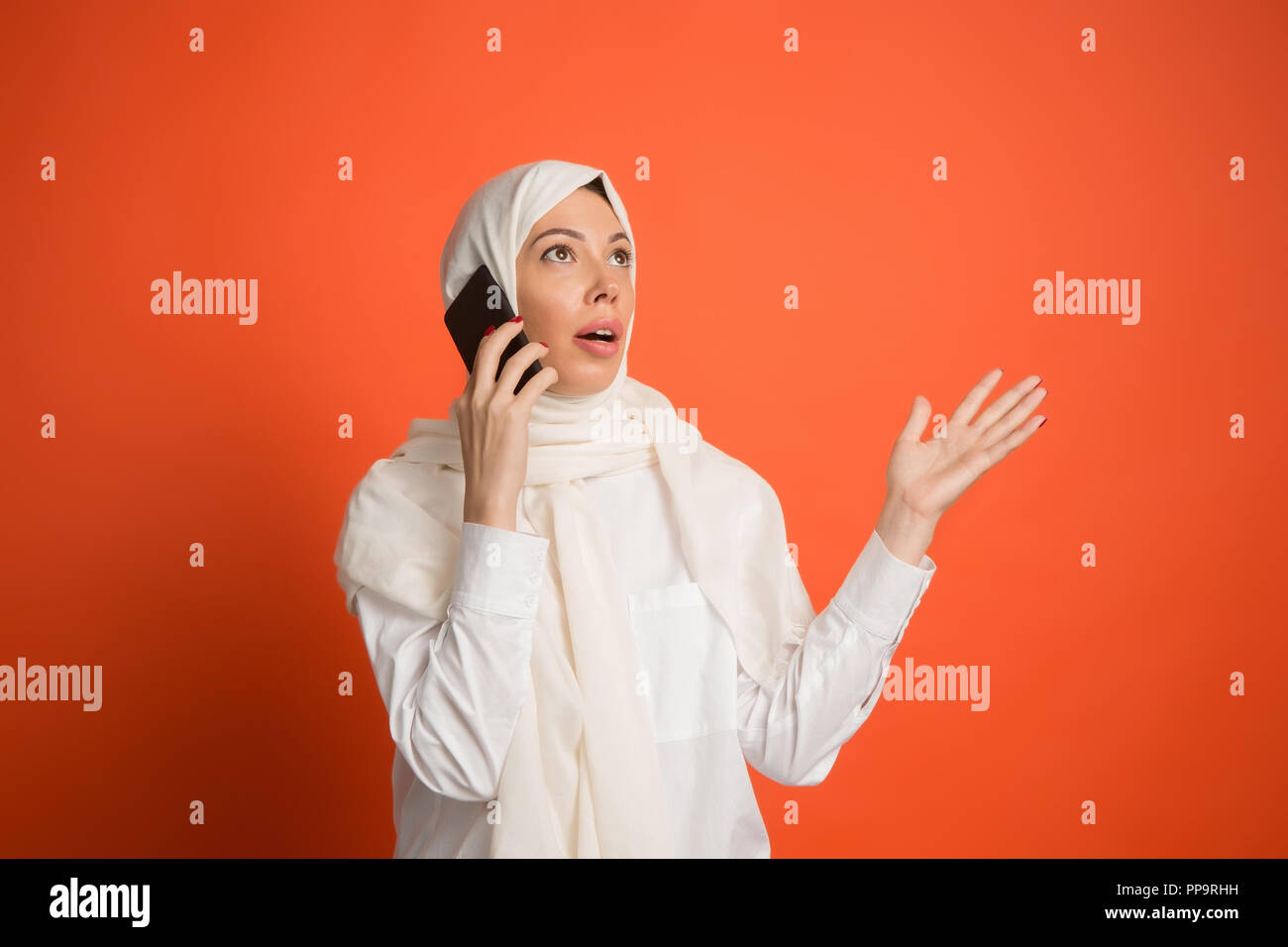 Happy arab woman in hijab with mobile phone. Portrait of smiling girl ...