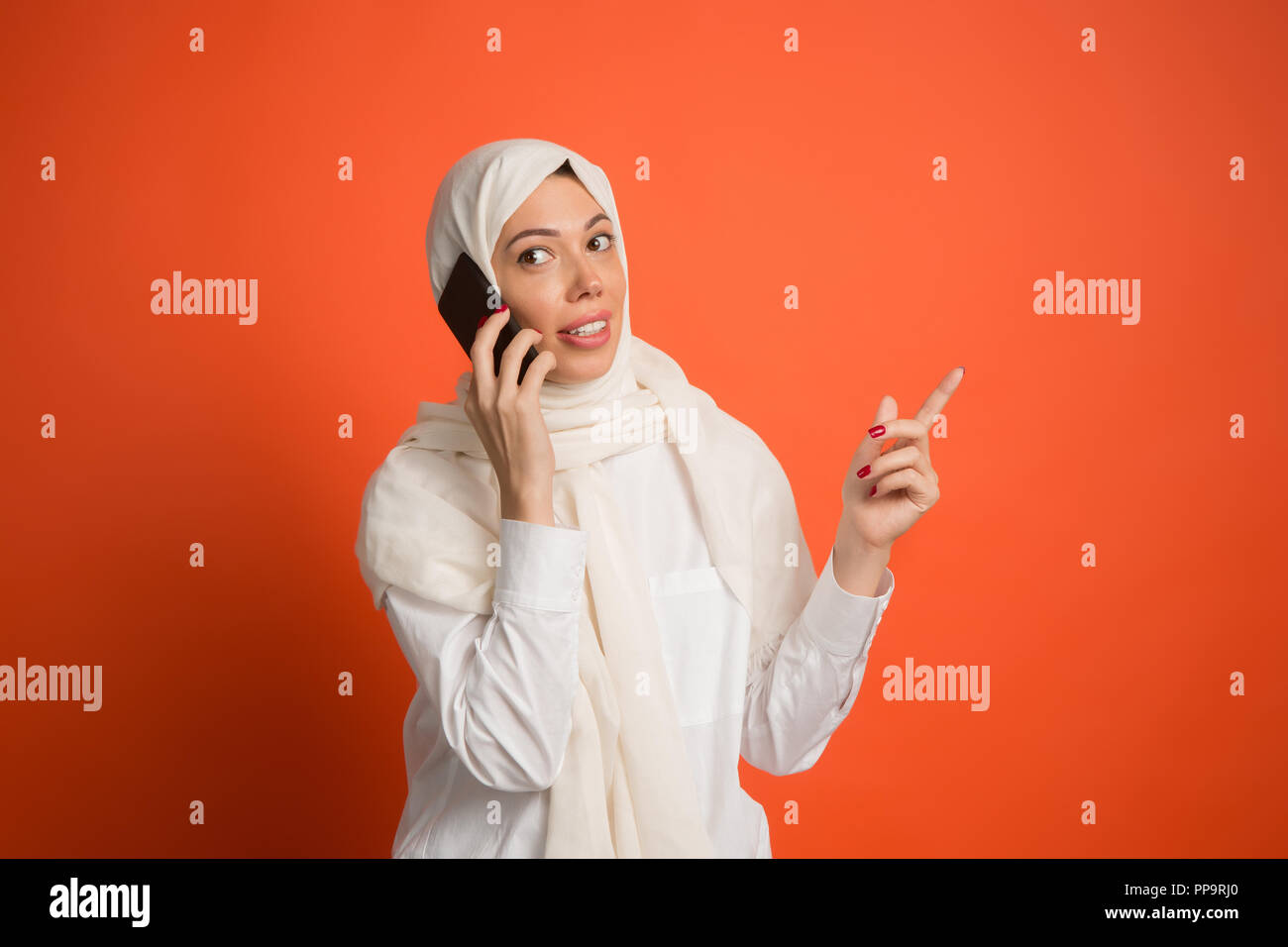 Happy arab woman in hijab with mobile phone. Portrait of smiling girl ...