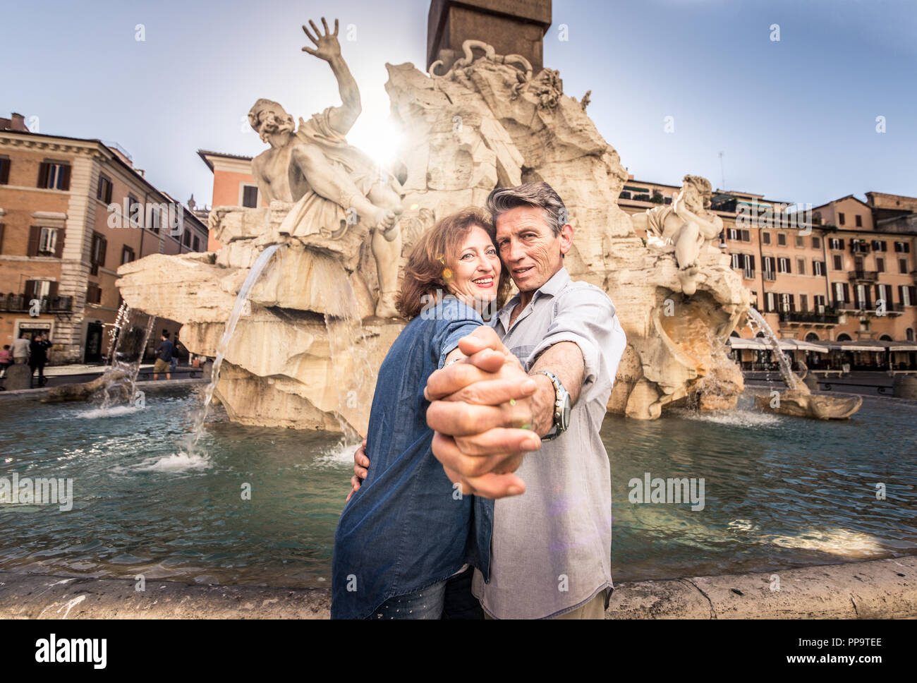 Senior couple at Navona square, Rome - Happy tourists visiting italian ...