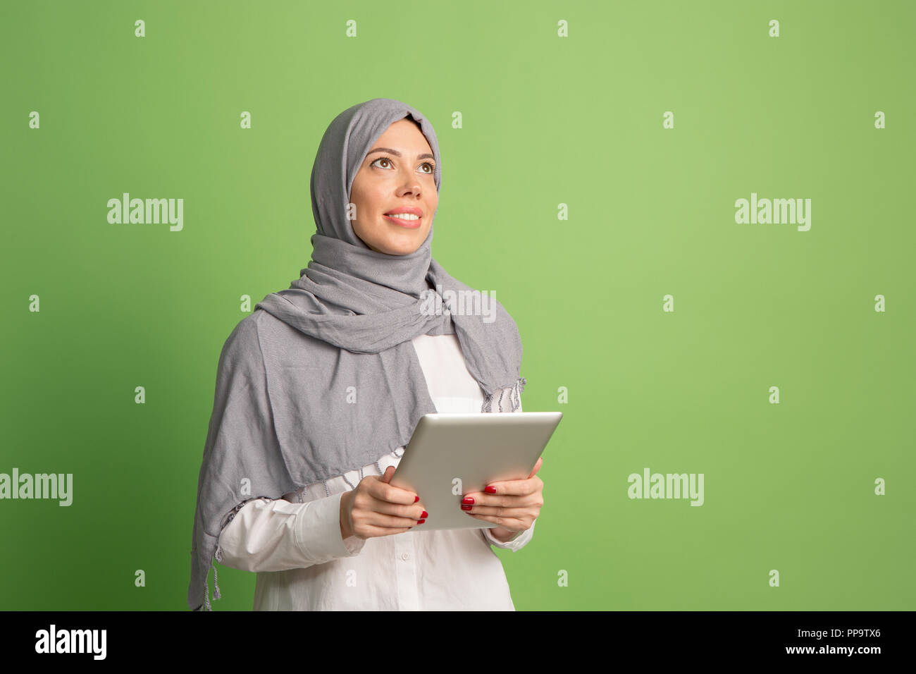 Happy arab woman in hijab with laptop. Portrait of smiling girl, posing ...
