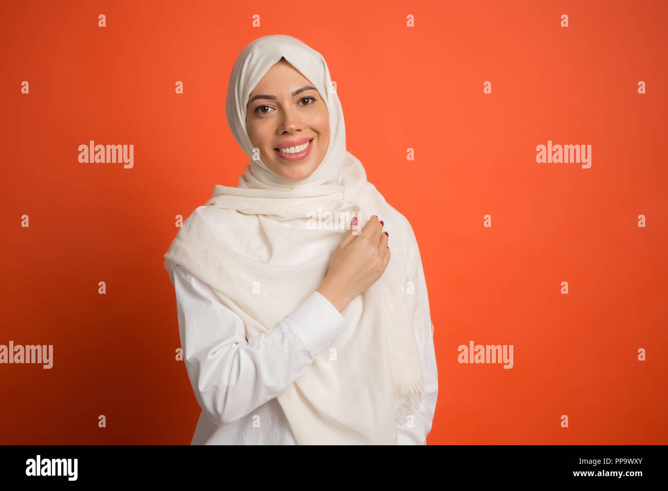 Happy arab woman in hijab. Portrait of smiling girl, posing at red ...