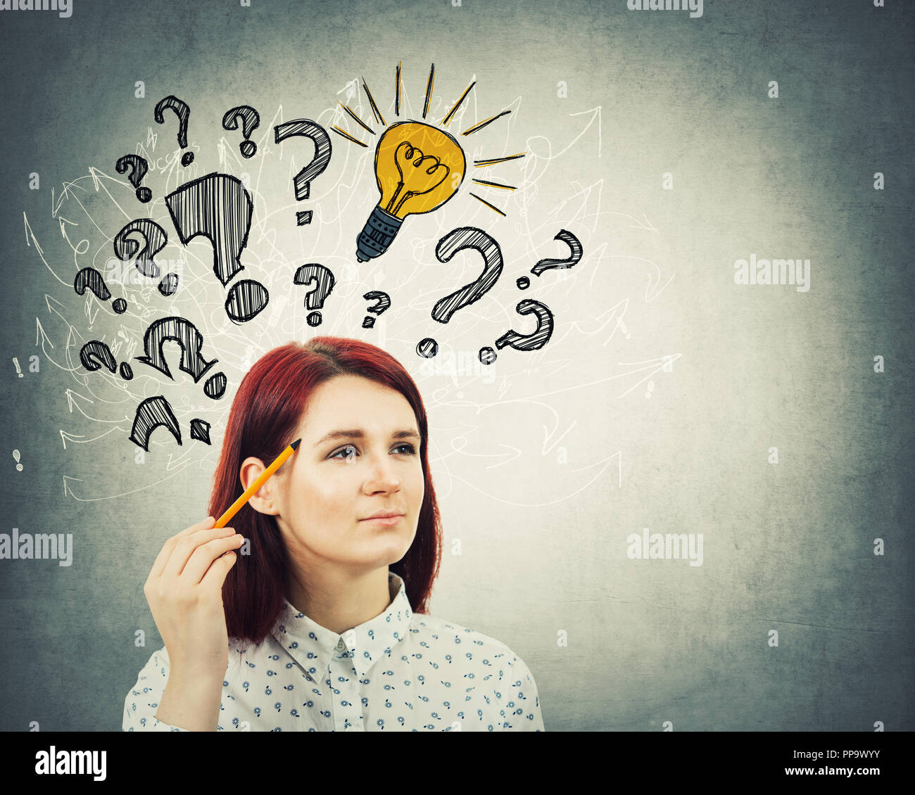 Young pensive woman holding pencil pointed to head drawing ...