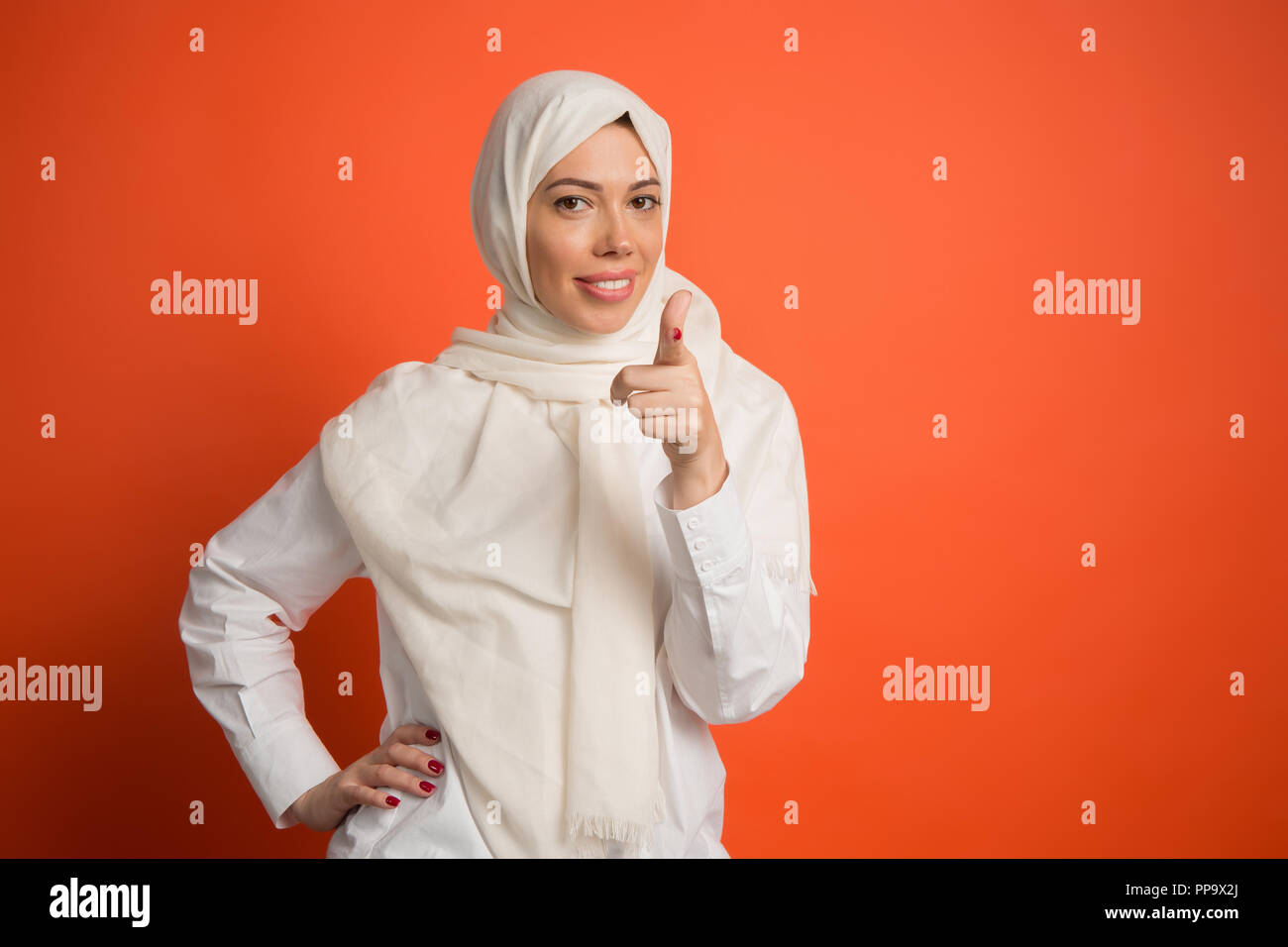 Happy arab woman in hijab. Portrait of smiling girl, pointing to camera ...