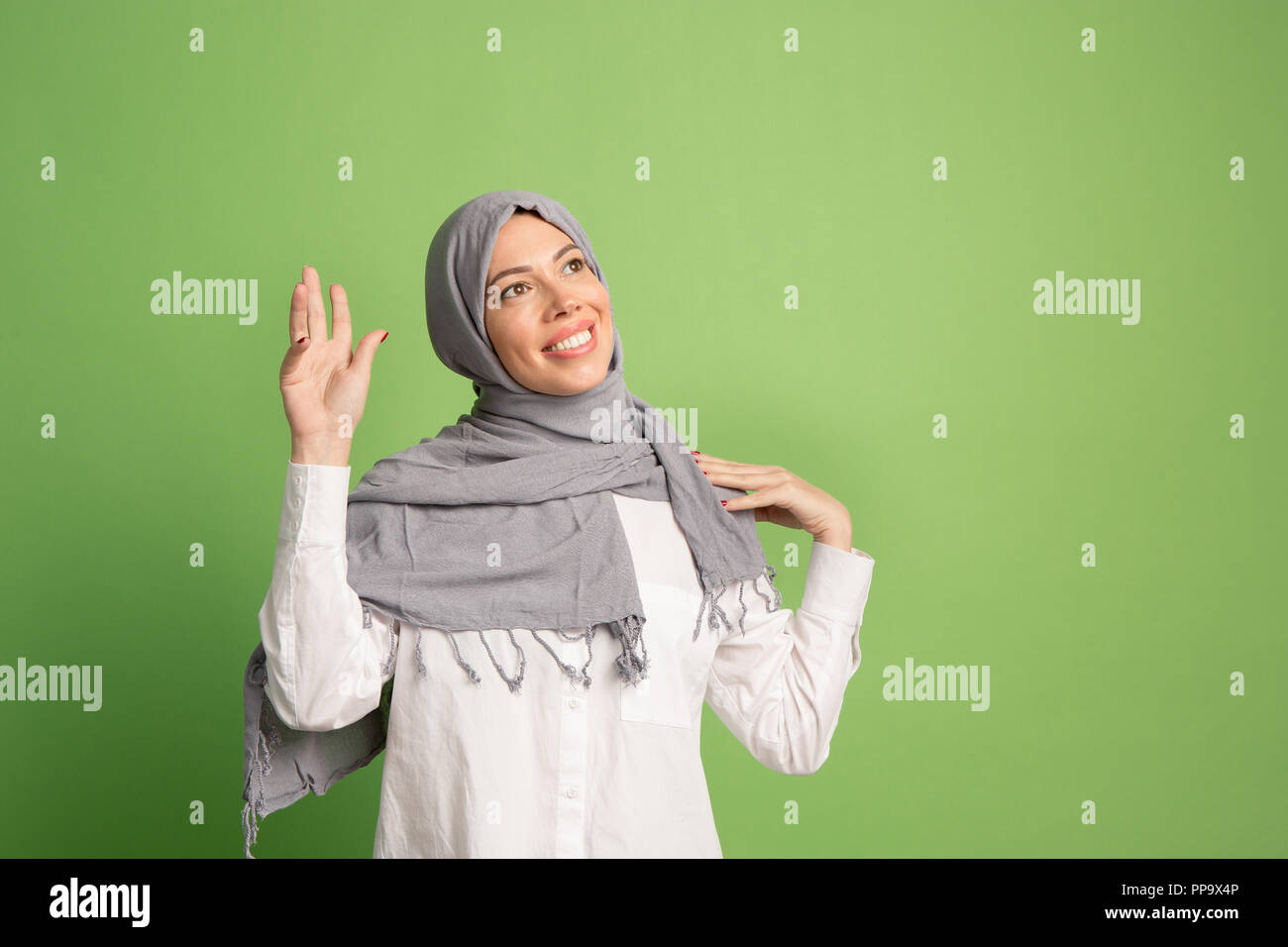 Happy arab woman in hijab. Portrait of smiling girl, posing at green ...