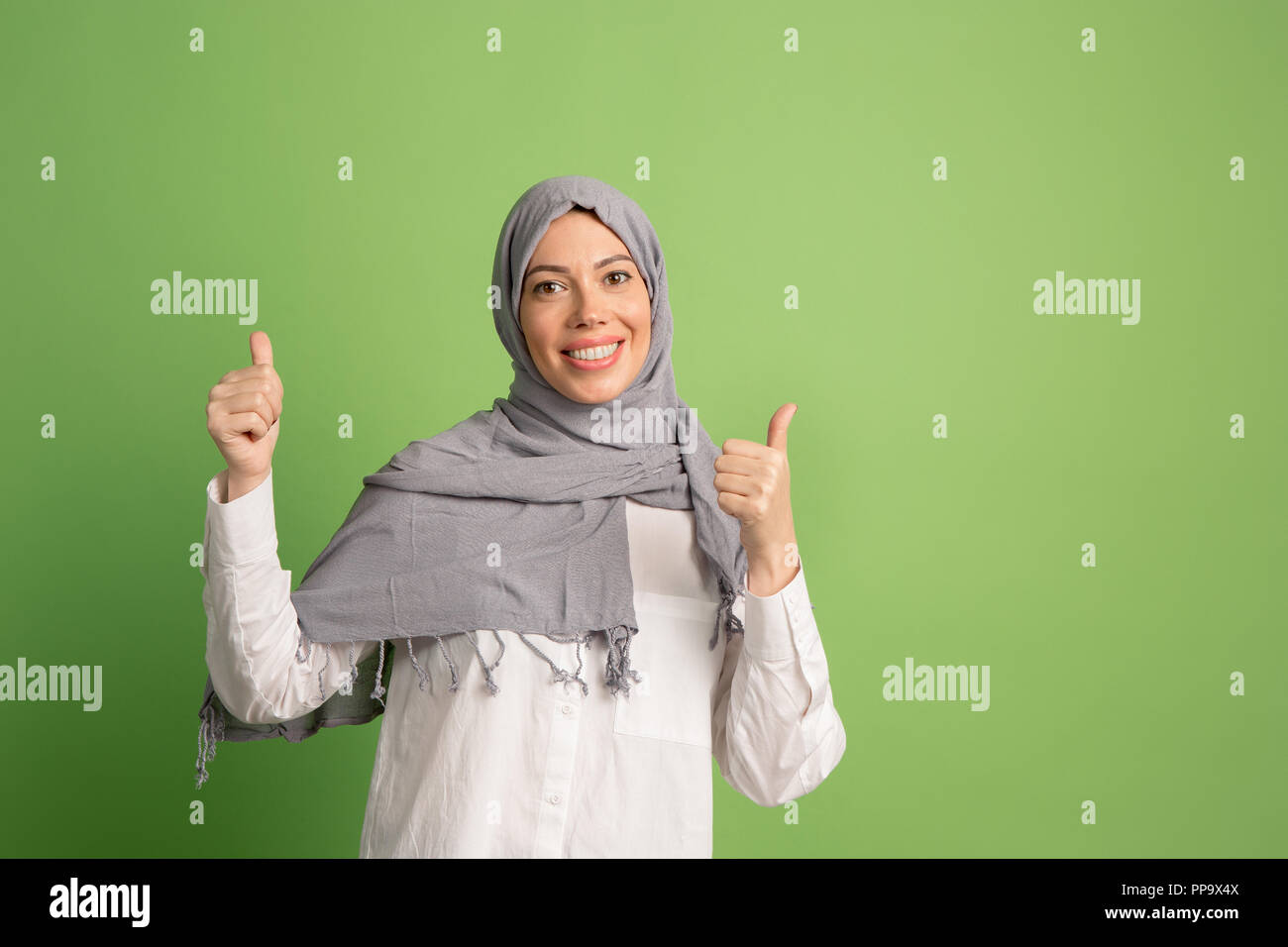 Happy arab woman in hijab. Portrait of smiling girl, posing at green ...