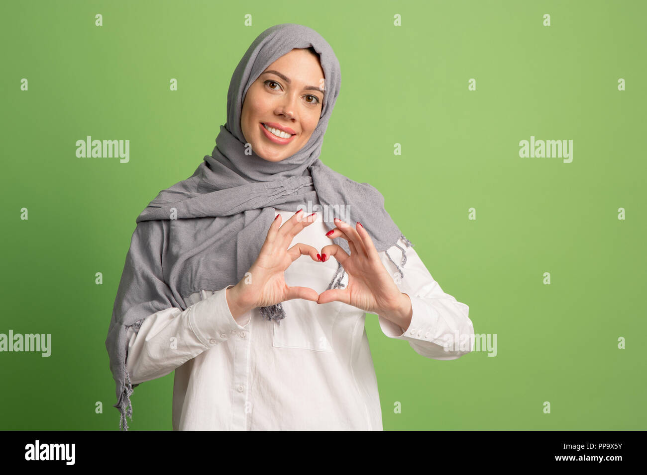 Happy arab woman in hijab. Portrait of smiling girl, posing at green ...