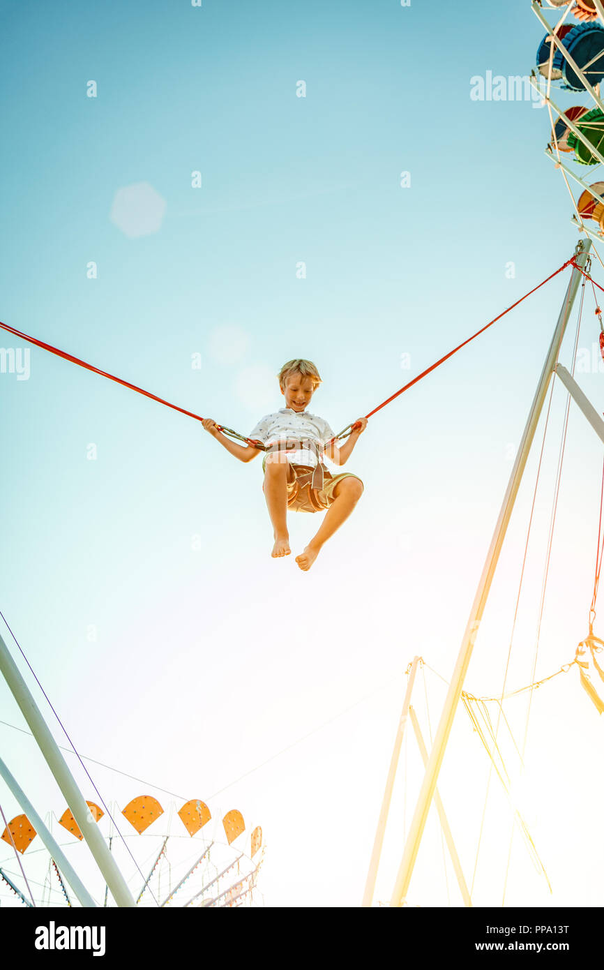 Smilling excited boy jumping on a trampoline with insurance Stock Photo ...