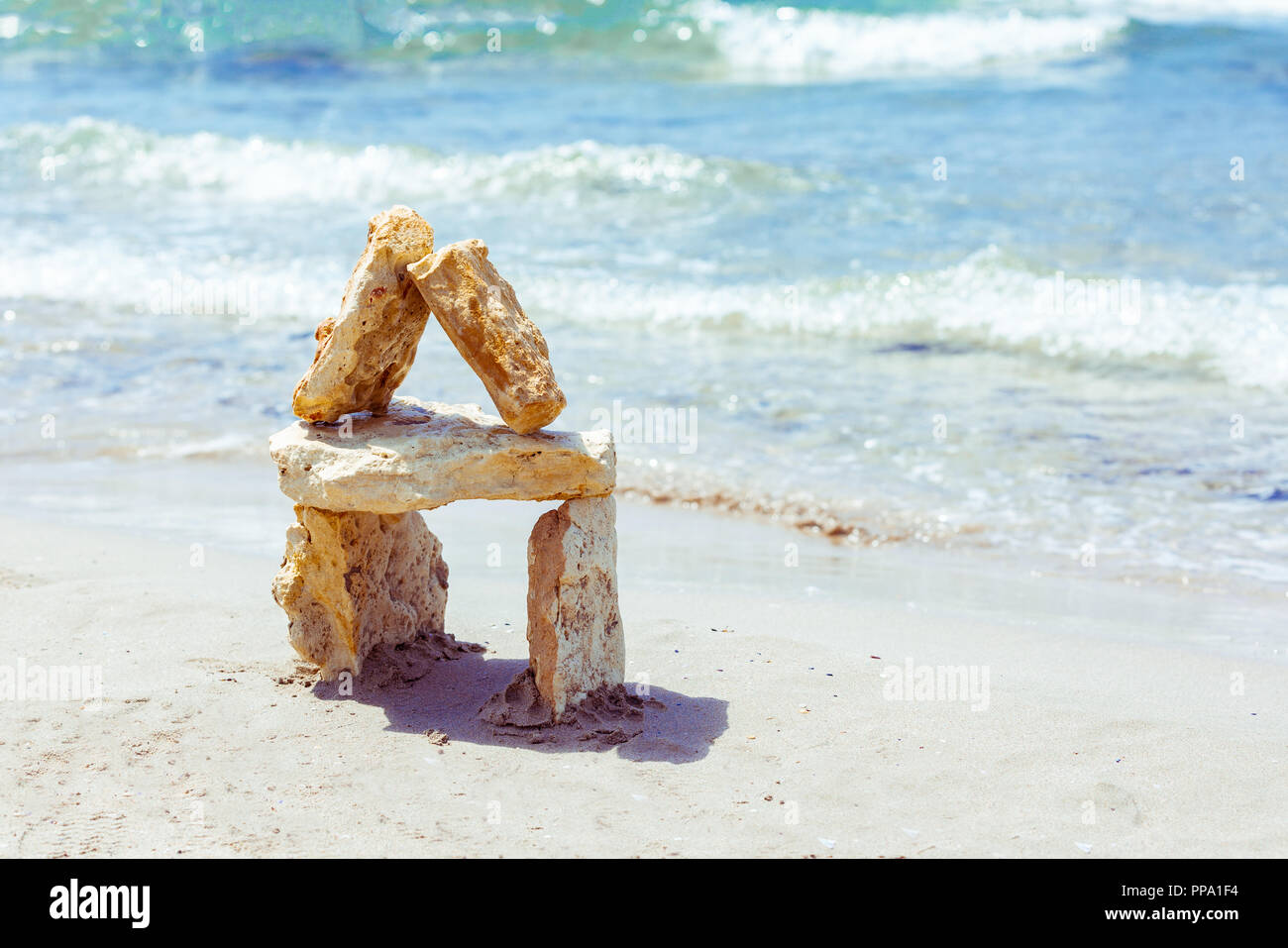 House made of stones against the sea, background sea. Sea stones on the ...