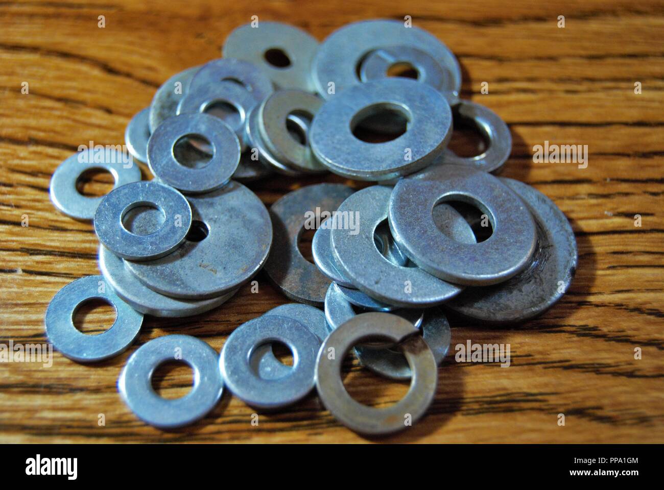 washers on wood background Stock Photo - Alamy