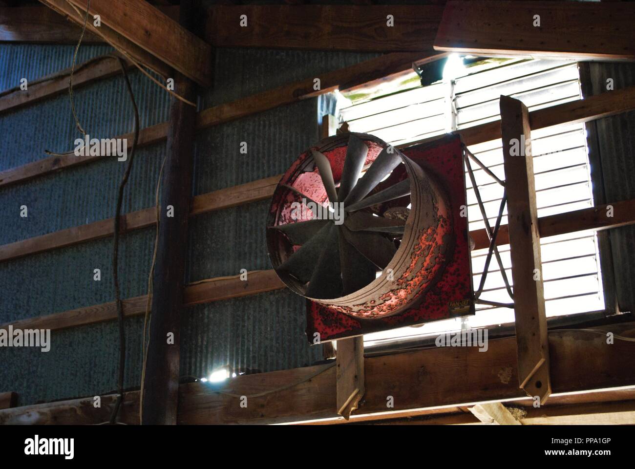 rusted farming fan in an abandoned barn Stock Photo - Alamy
