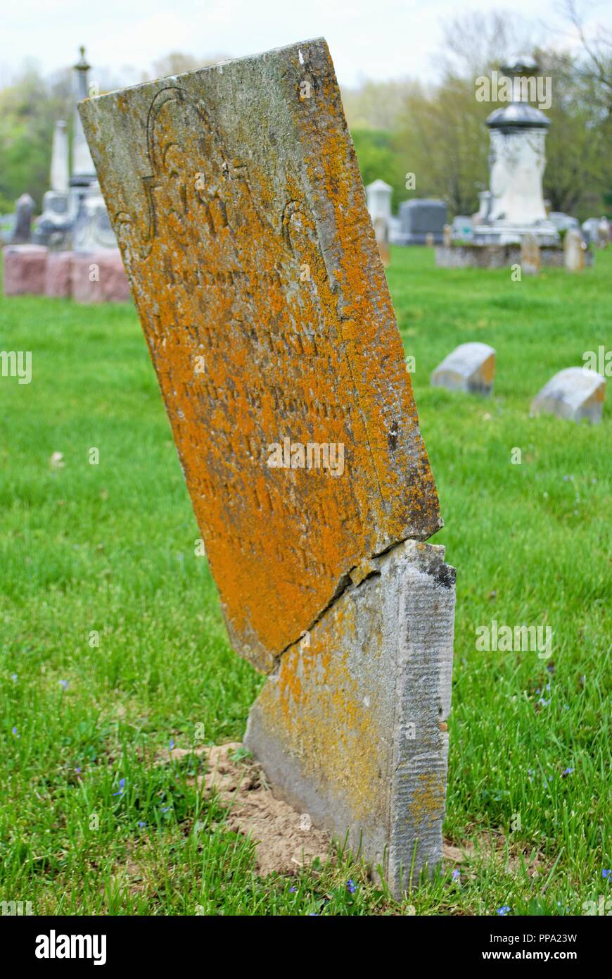 very old moss covered broken statue / headstone in a cemetery Stock ...