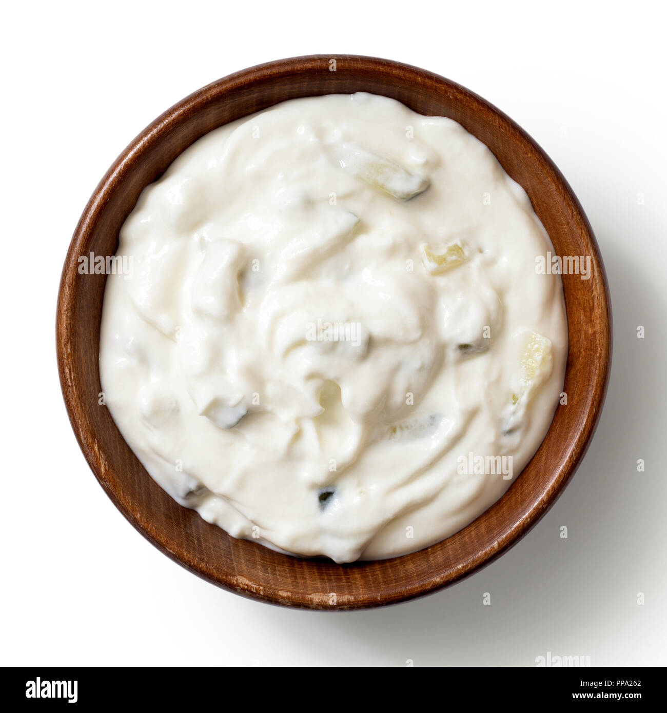 Tzatziki in brown rustic wood bowl isolated on white from above Stock ...