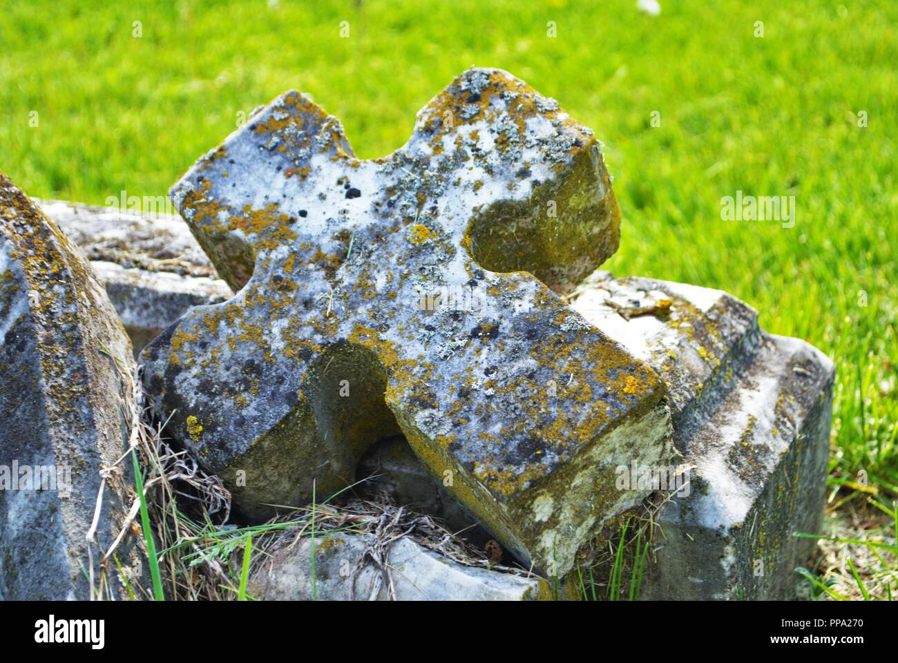 very old moss covered broken statue / headstone in a cemetery Stock ...