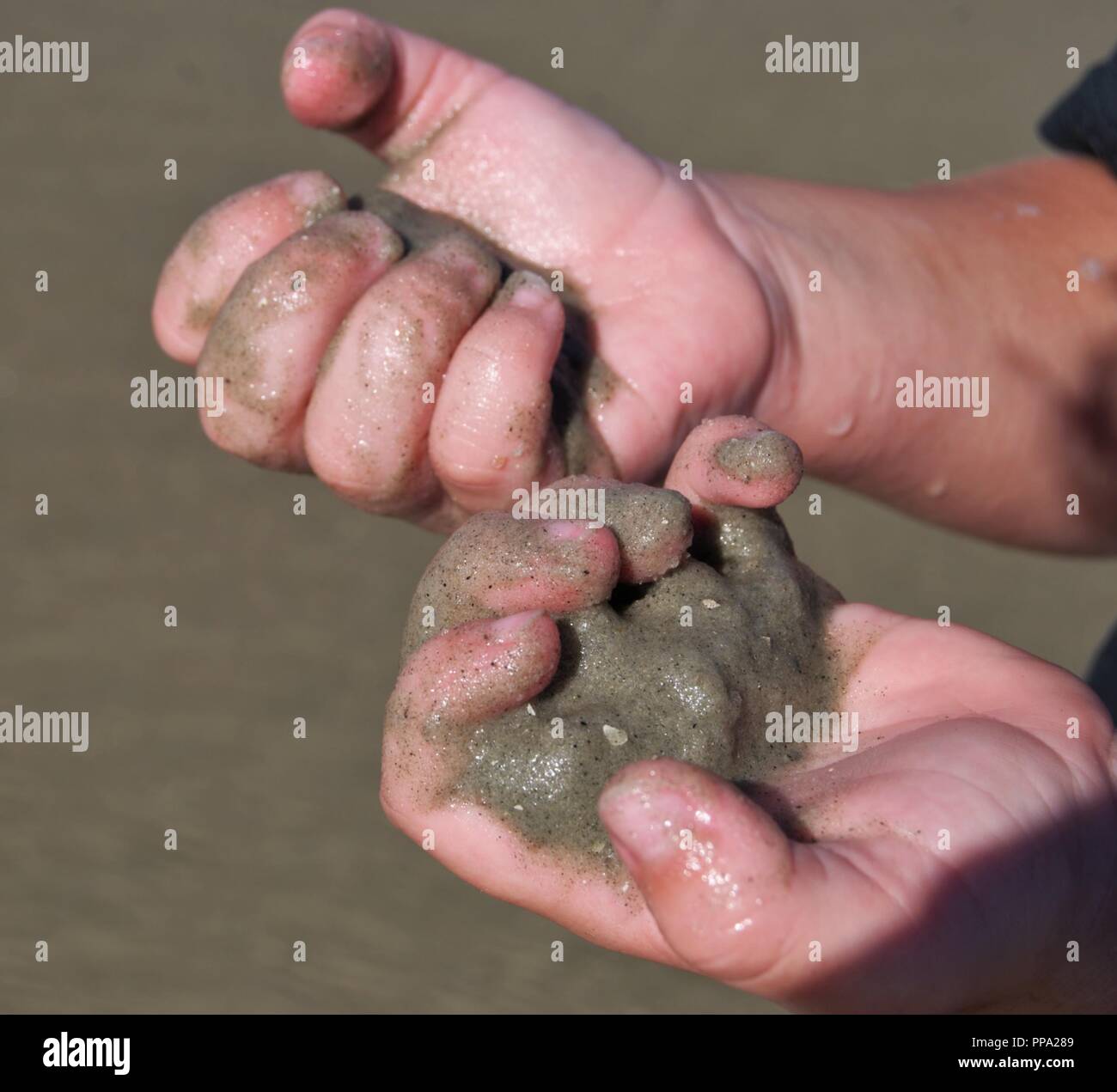 sand in a childs hand Stock Photo - Alamy