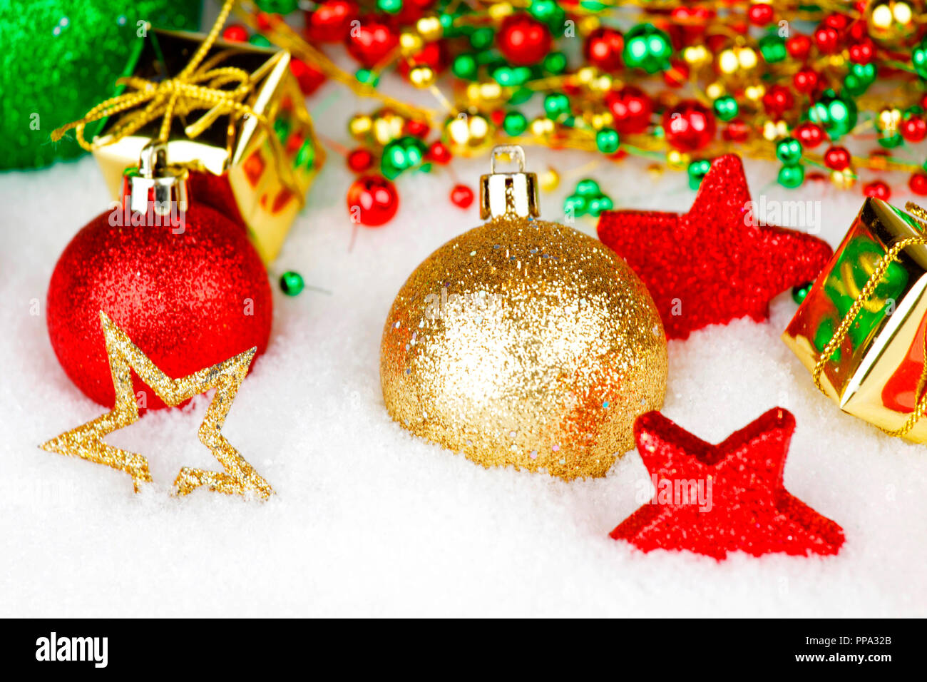 Beautiful colorful christmas decoration in snow Stock Photo - Alamy