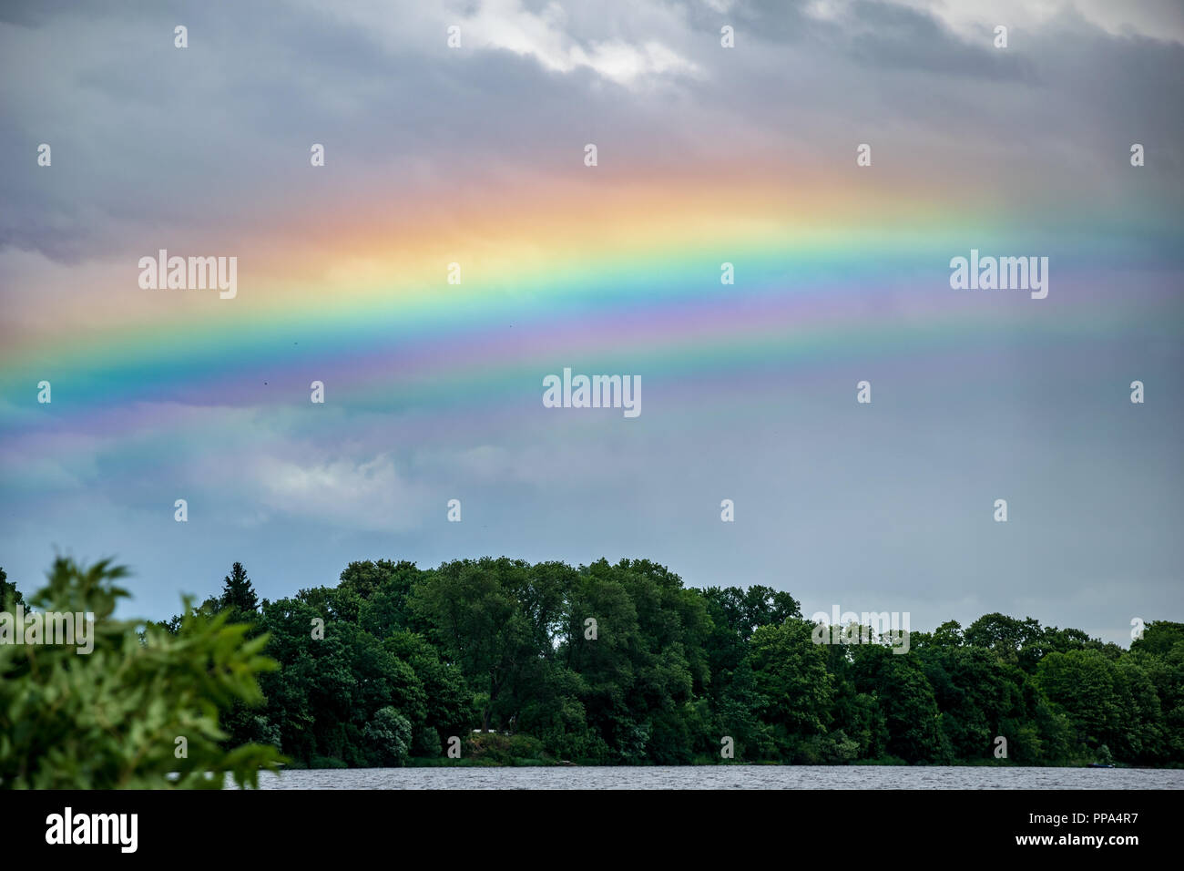 rainbow over the country fields on a stormy clouded sky Stock Photo - Alamy