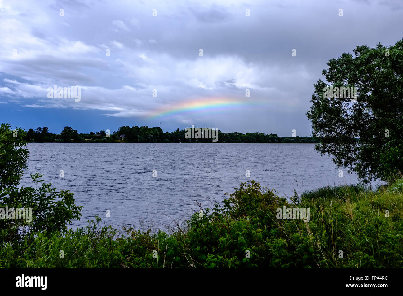 rainbow over the country fields on a stormy clouded sky Stock Photo - Alamy