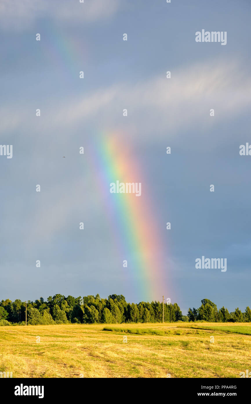 rainbow over the country fields on a stormy clouded sky Stock Photo - Alamy