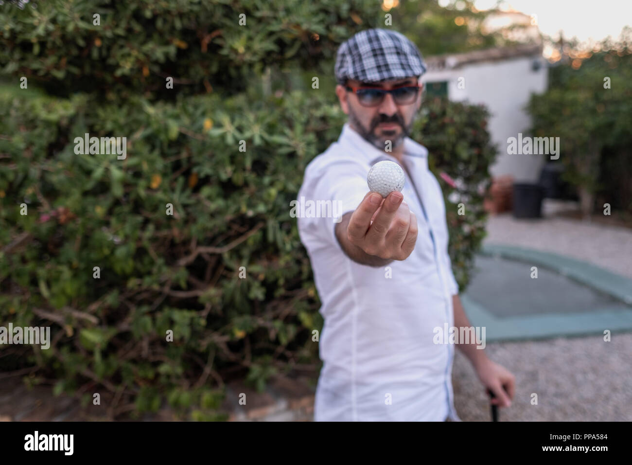 man showing golf ball in his hands Stock Photo - Alamy
