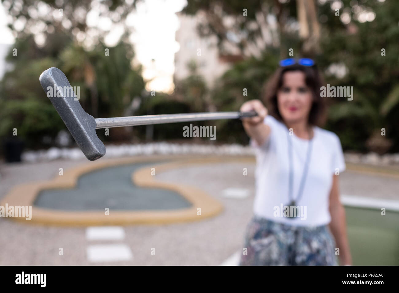 girl showing golf club with one hand Stock Photo - Alamy