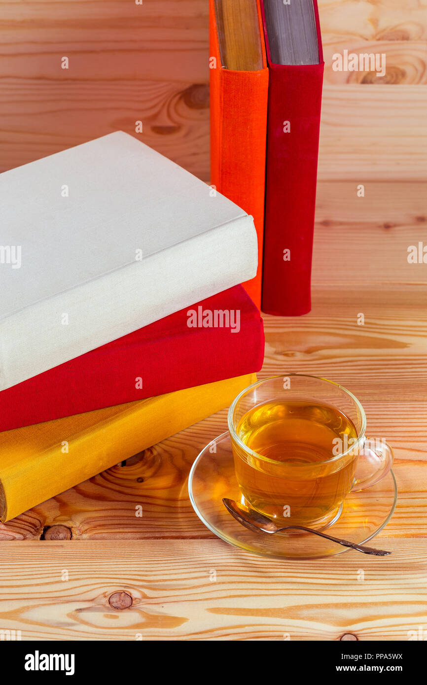 Glass cup with tea and a stack of books with colorful covers Stock ...