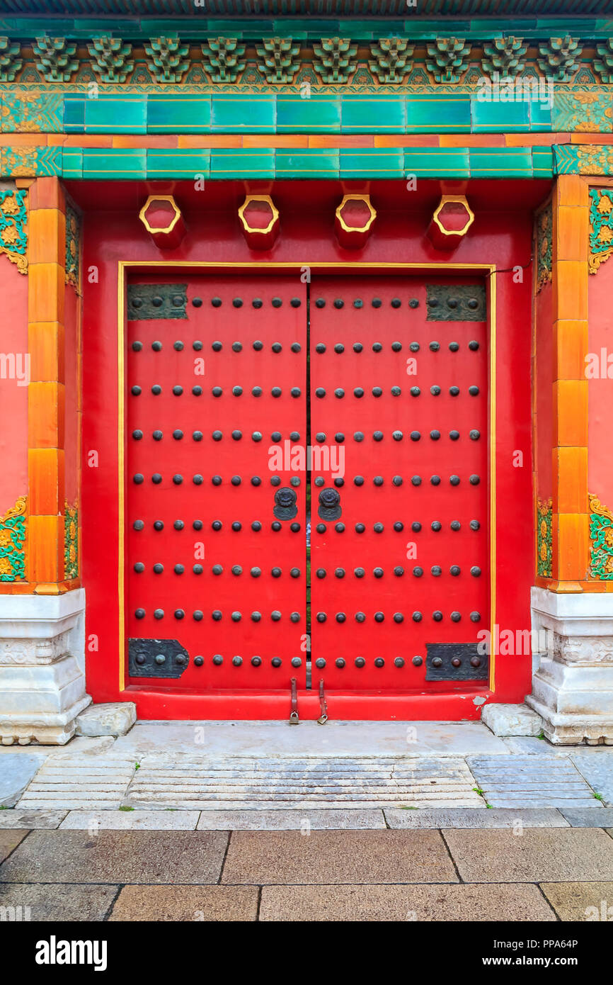 Ornate red wooden door with tile trim and traditional Chinise design at ...