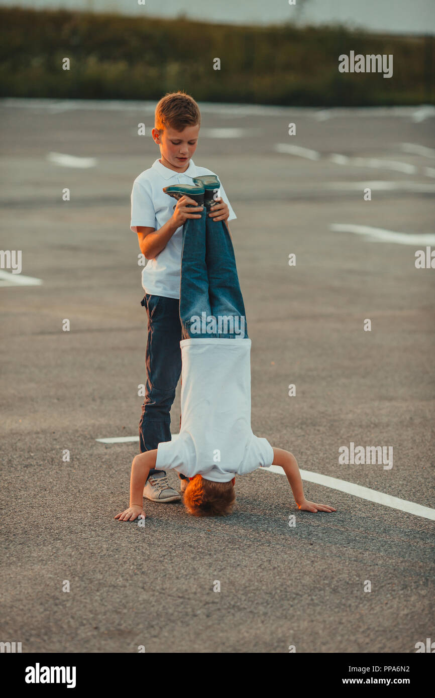 The boy standing upside down in the summer outdoors Stock Photo - Alamy
