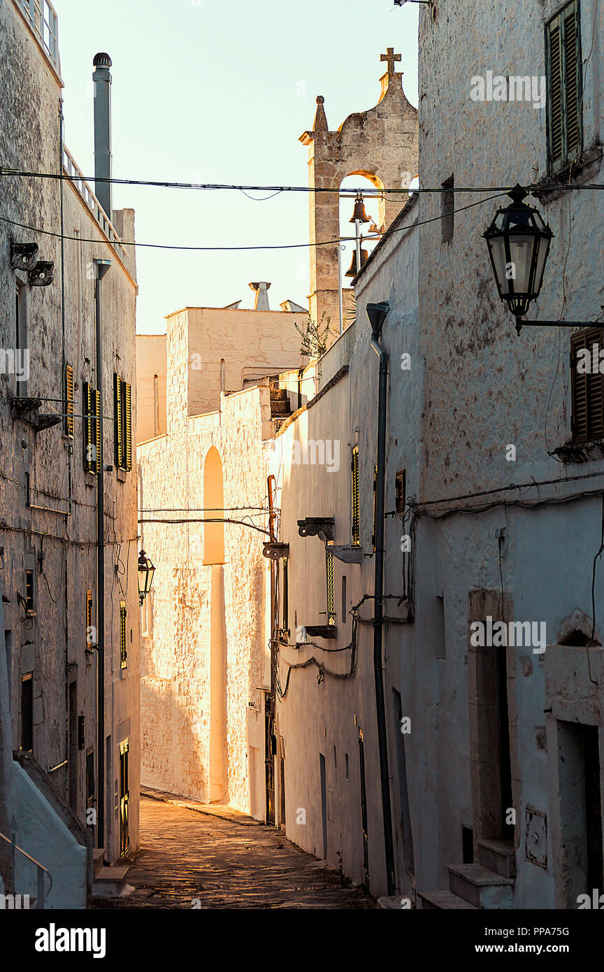Scenic little street in the white village of Ostuni in Salento on the ...