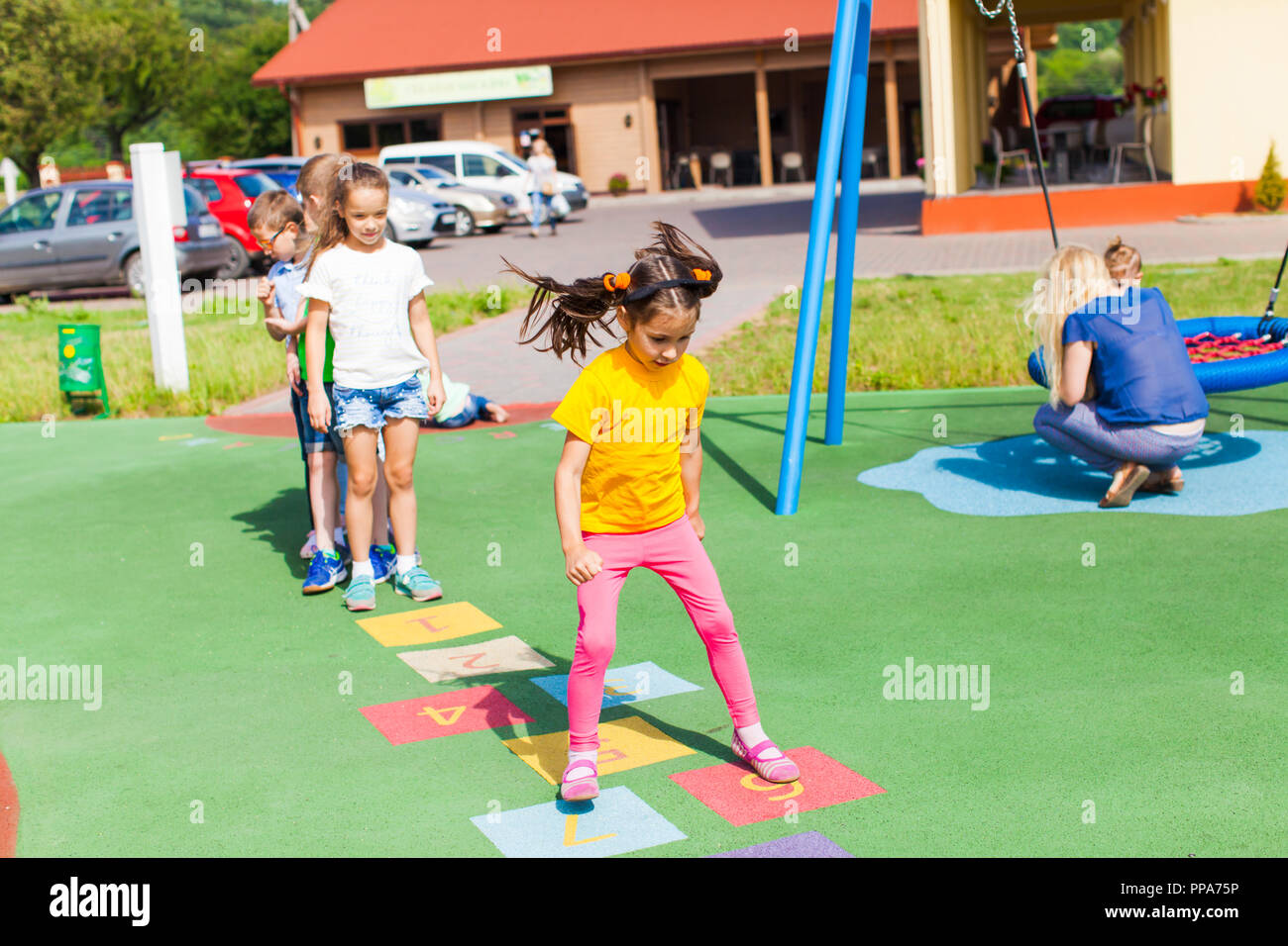 the girlfriends have fun playing hopscotch in the summer outdoors Stock ...