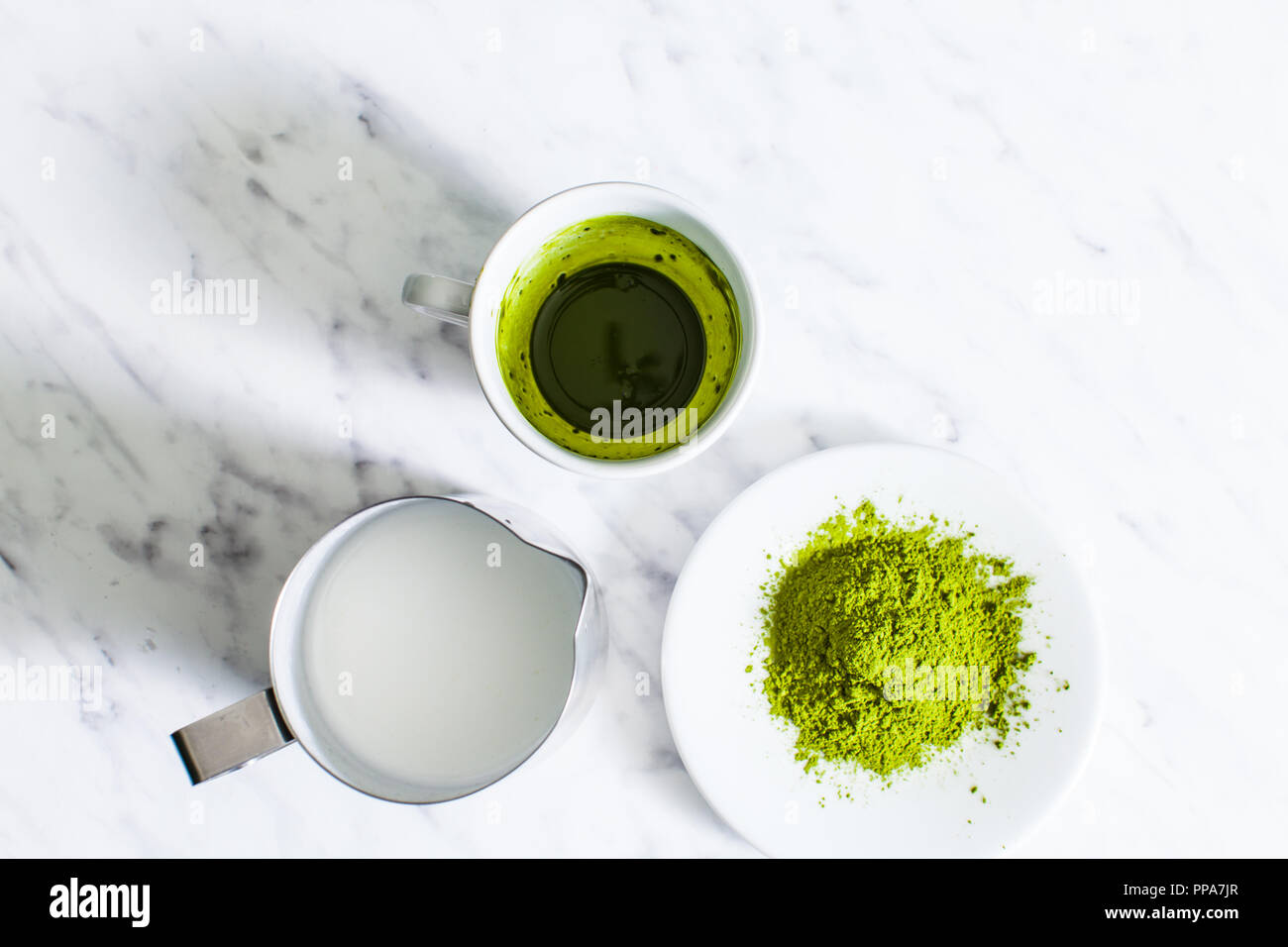 A cup of green Matcha tea with milk jug Stock Photo - Alamy