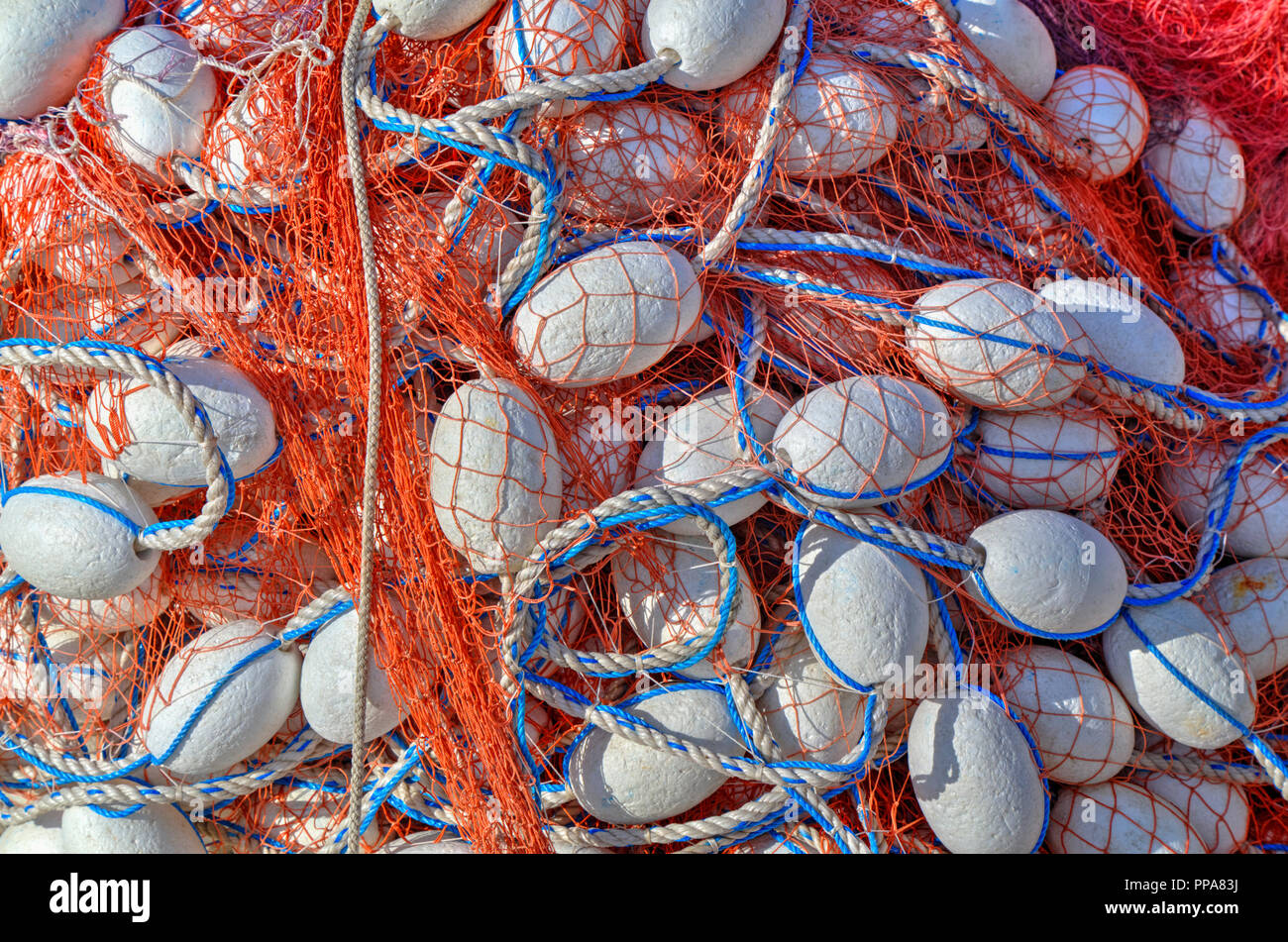Pile of fishing nets closeup Stock Photo - Alamy