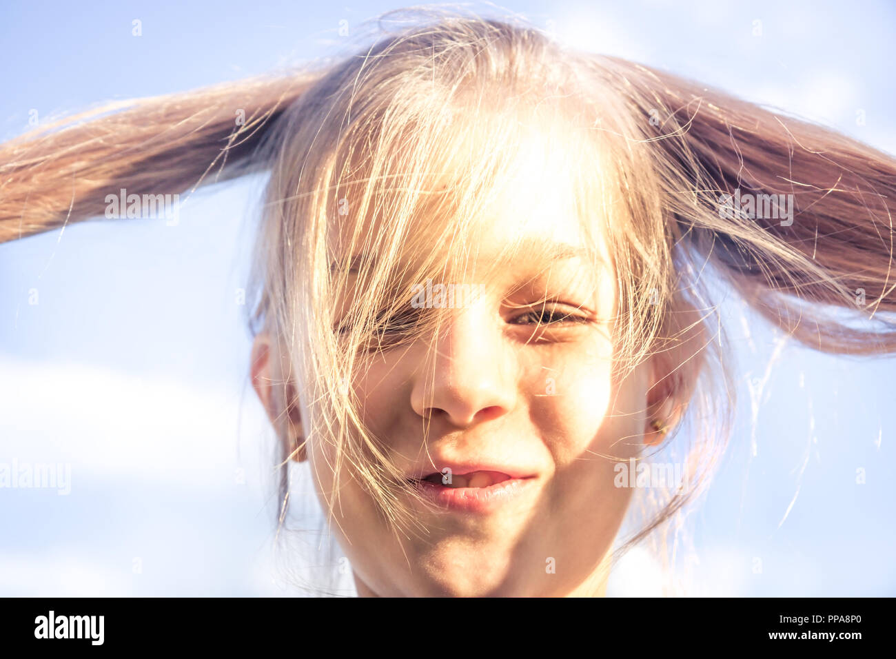 Funny Mischievous smiling child girl sunny portrait with hair cut ...