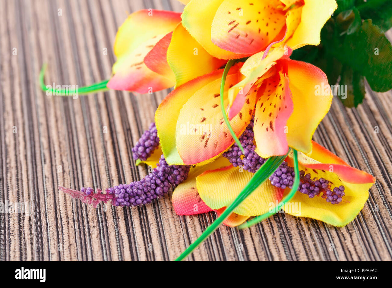 Colorful artificial flowers on cloth background, closeup picture Stock ...