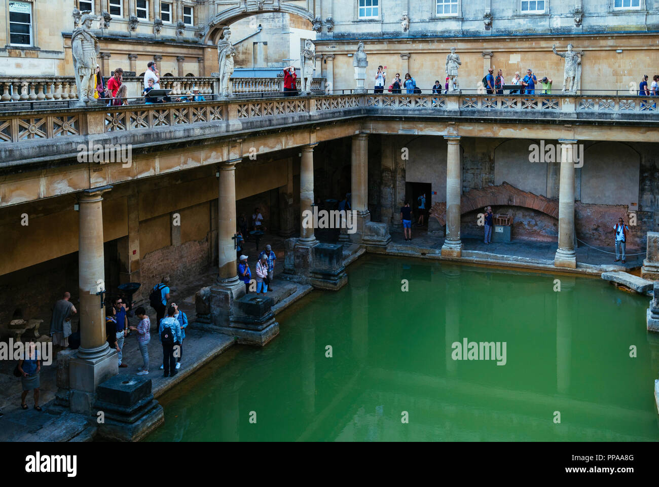 Visitors exploring the Terrace and Great Bath of the Roman Baths, in ...