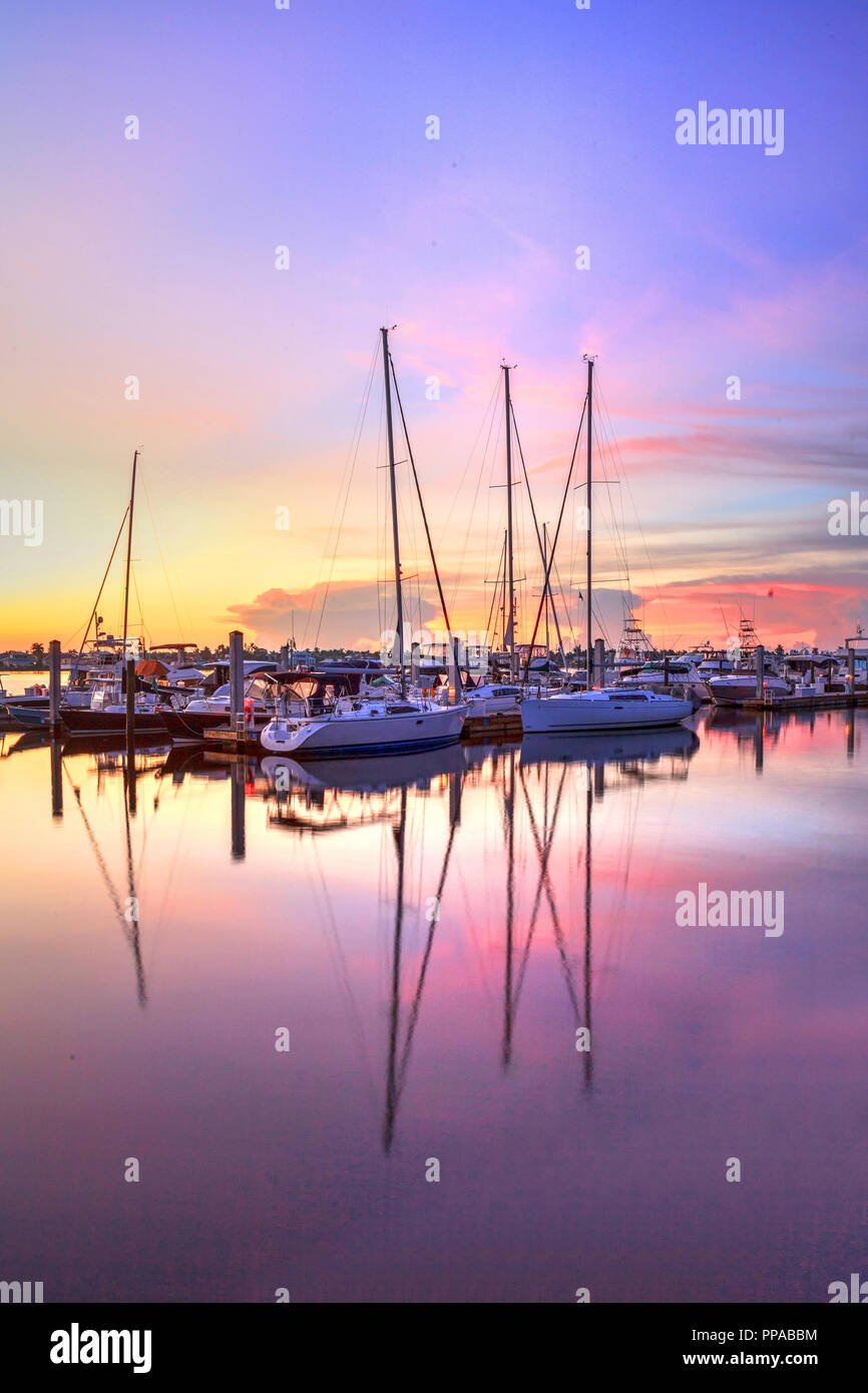 Sunrise over a quiet harbor in old Naples, Florida during the summer ...