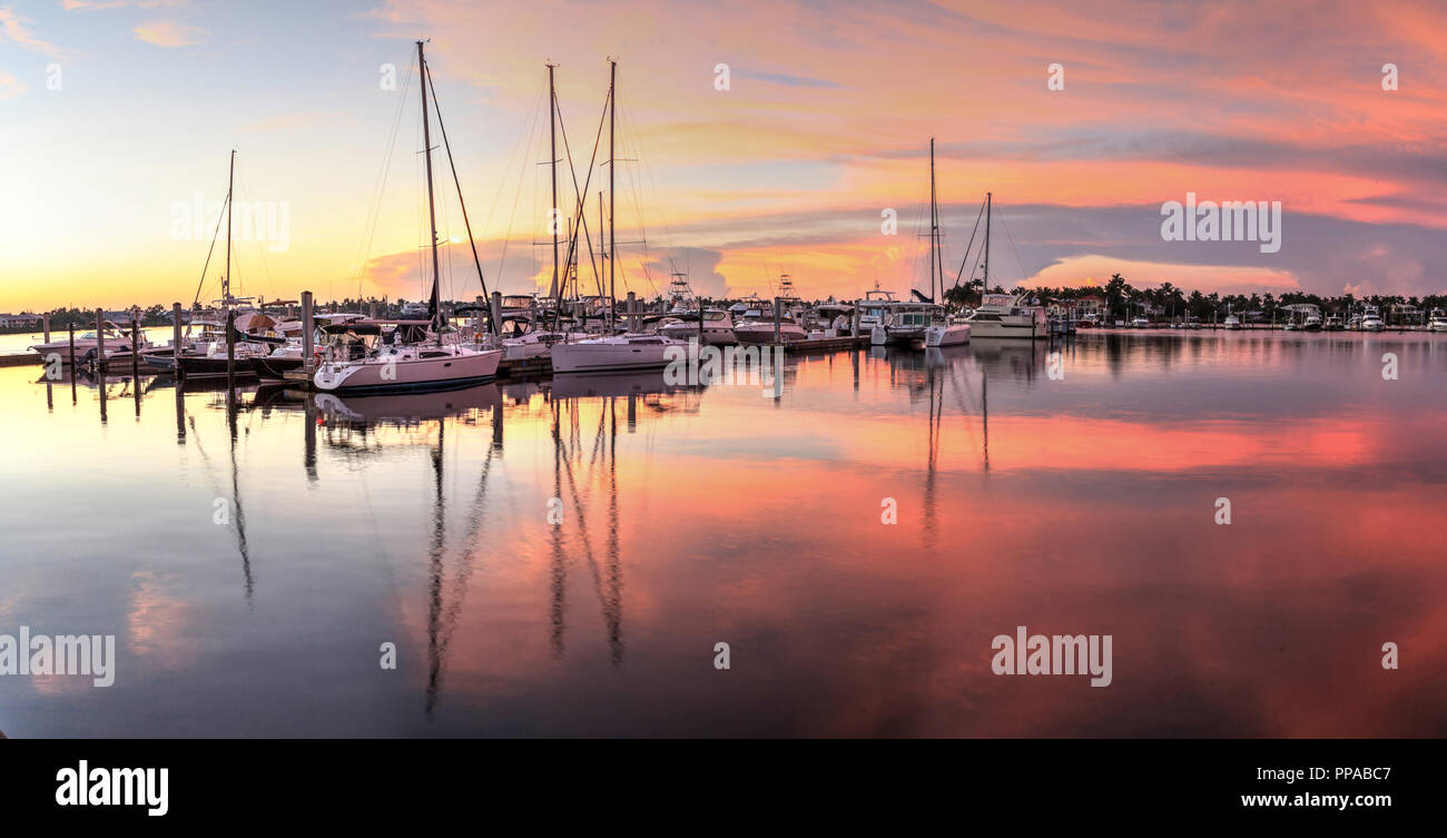 Sunrise over a quiet harbor in old Naples, Florida during the summer ...