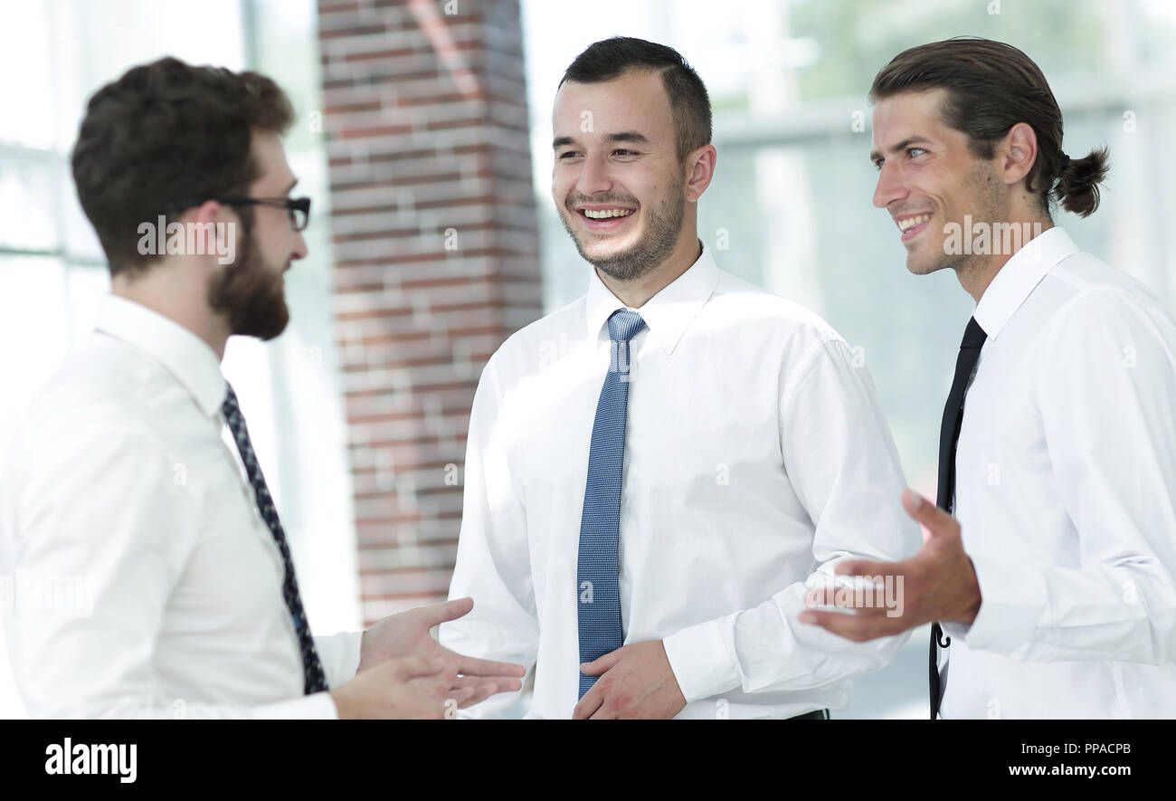 employees are talking ,standing in the office Stock Photo - Alamy
