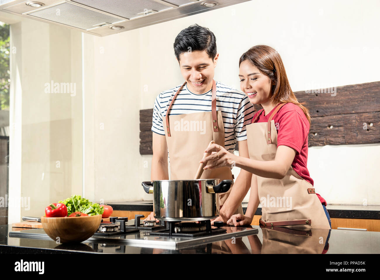 Asian couple cooking hi-res stock photography and images - Alamy