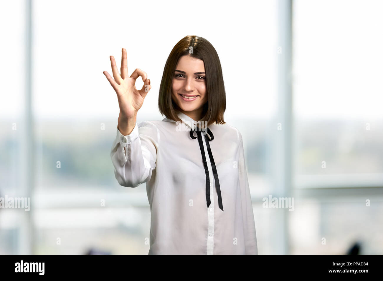 Beautiful woman showing ok sign Stock Photo - Alamy