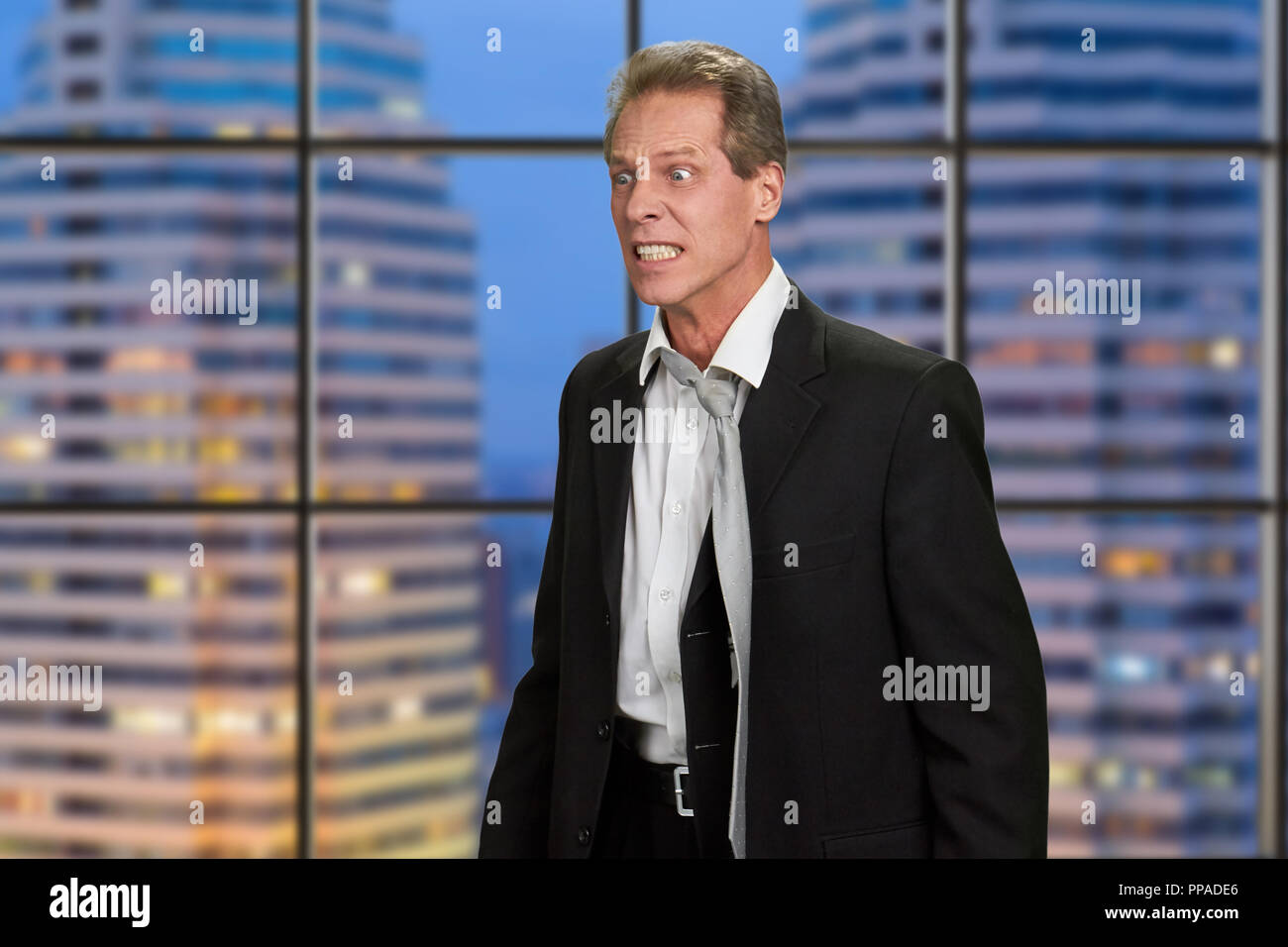 Angry irritated boss on skyscraper background Stock Photo - Alamy