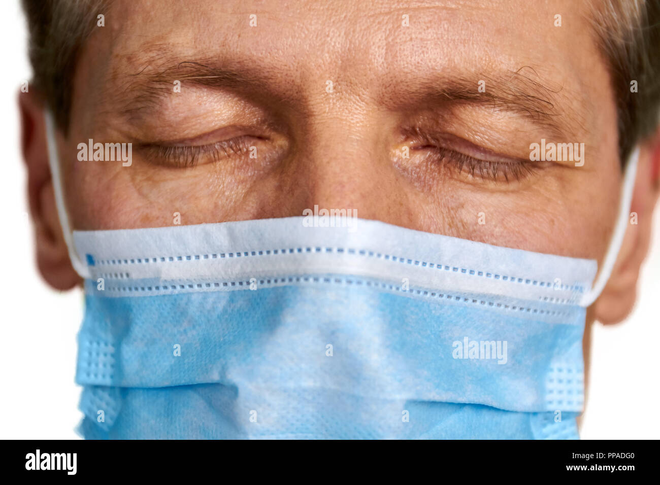 Close up doctor in mask closed eyes Stock Photo - Alamy
