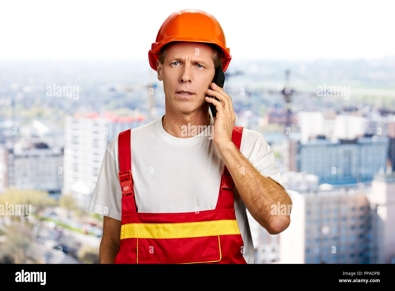 Construction contractor talking on cellphone hi-res stock photography ...