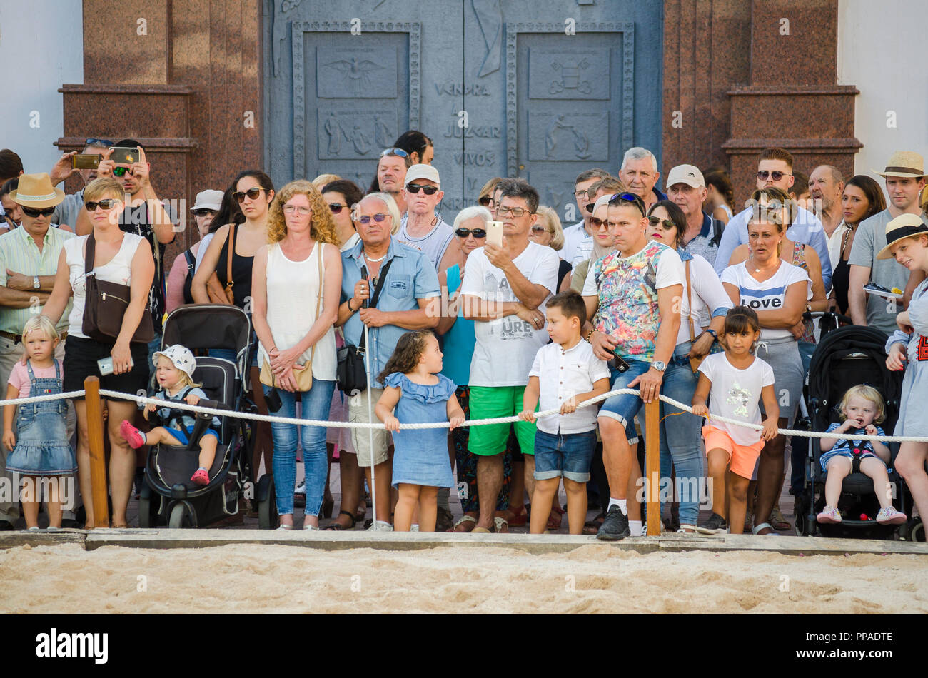 Group of people watching an event. Fuengirola, Spain Stock Photo - Alamy