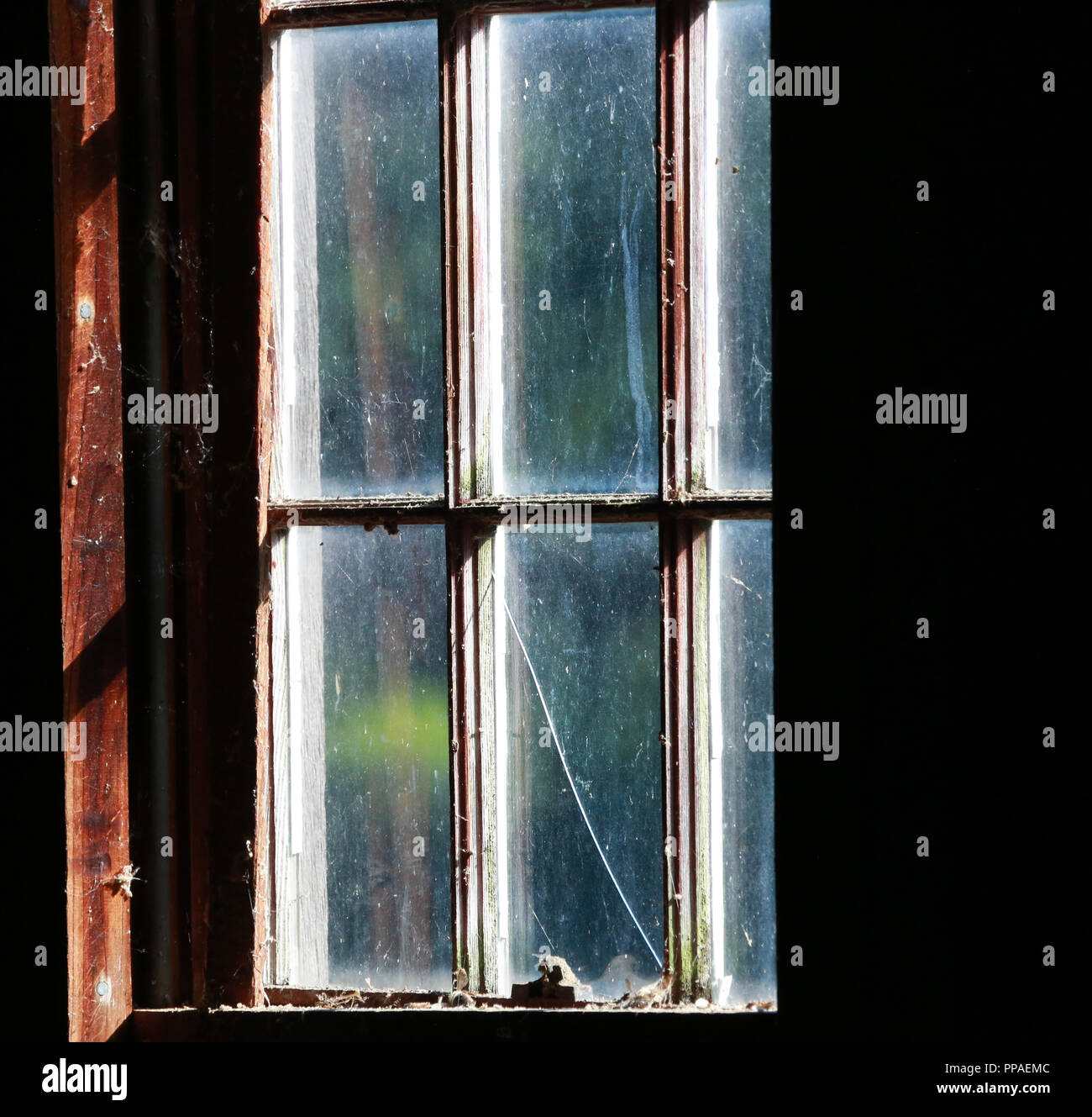 sunlight shinning through dirty window frame from inside historic saw ...