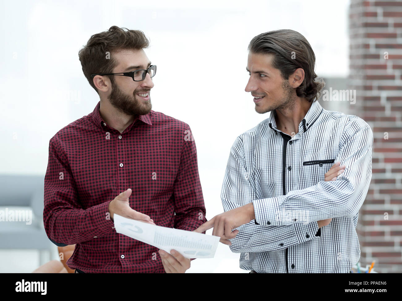two office employee talking in the office Stock Photo - Alamy