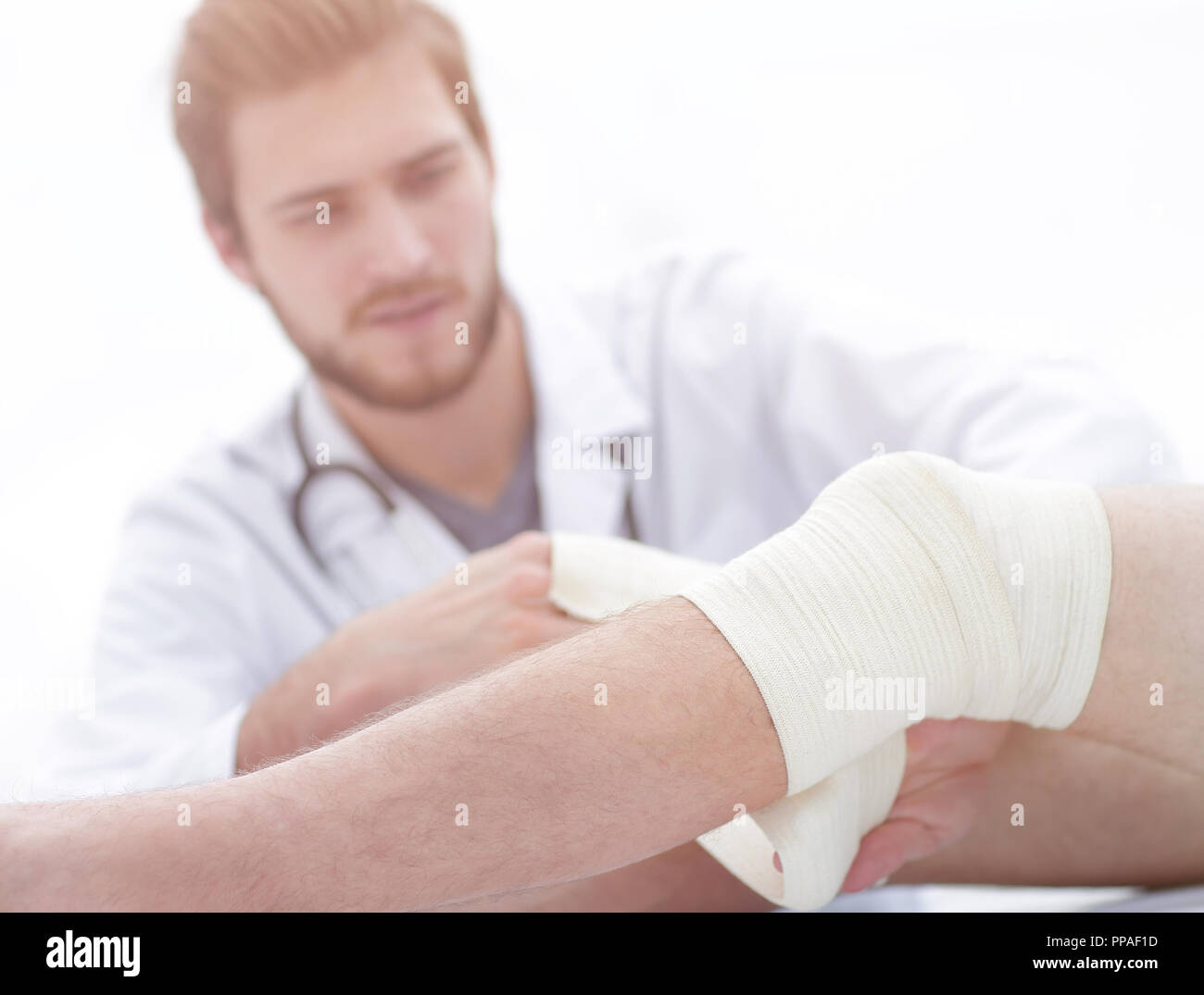 doctor bandaging a wound on the leg of the patient Stock Photo - Alamy